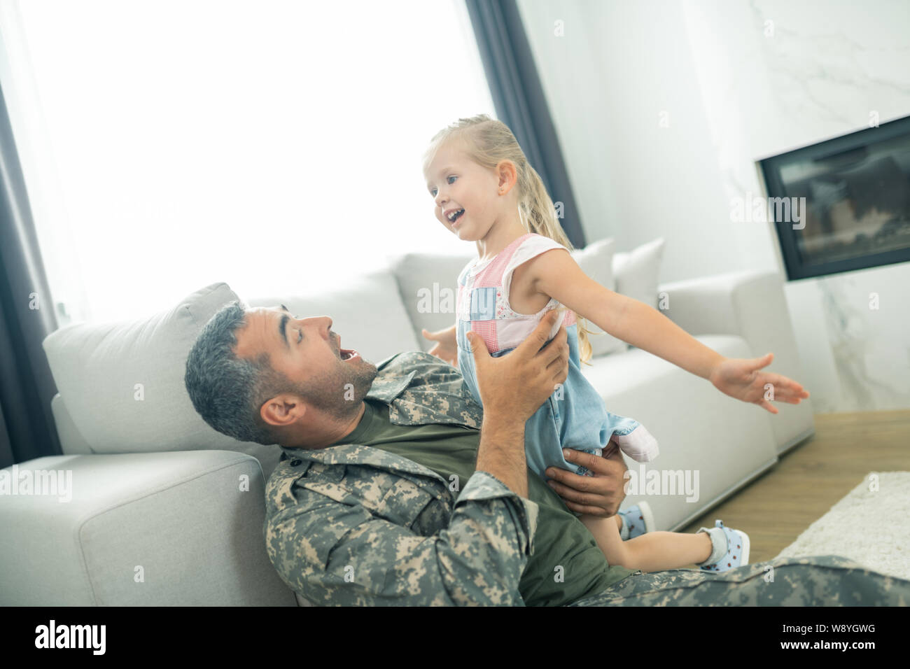 Daughter feeling involved while spending time with daddy Stock Photo ...