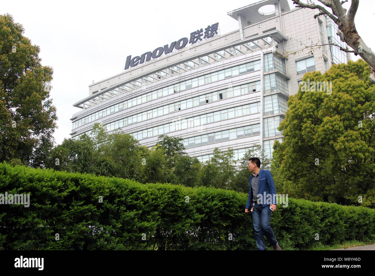 --FILE--A pedestrian walks past an office building of Lenovo Group in ...