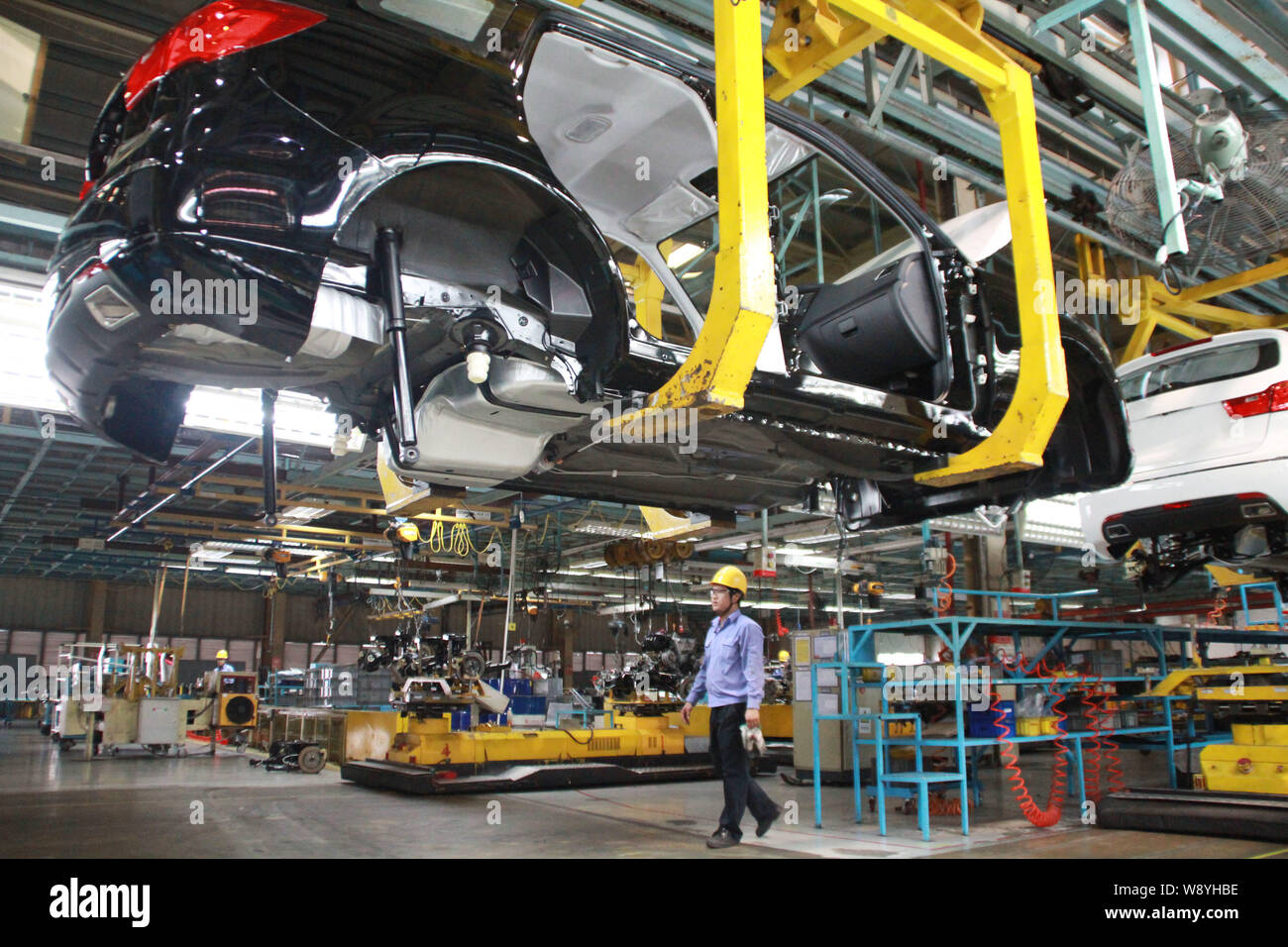 --FILE--Chinese workers assemble cars on the assembly line at the auto ...