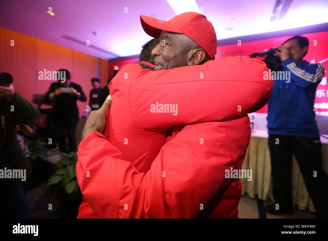 Chinese professional boxer Zhang Junlong, left, hugs retured U.S. boxer ...
