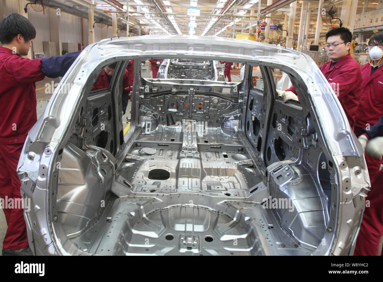 --FILE--Chinese workers assemble a car on the assembly line at the auto ...
