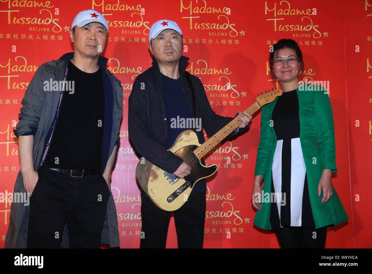 Chinese singer-songwriter Cui Jian, left, poses with the wax figure of ...