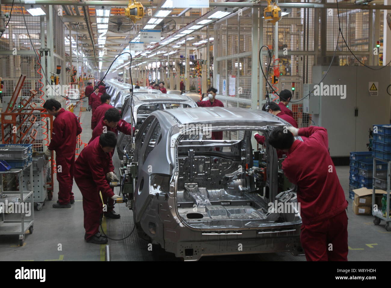 --FILE--Chinese workers assemble cars on the assembly line at the auto ...
