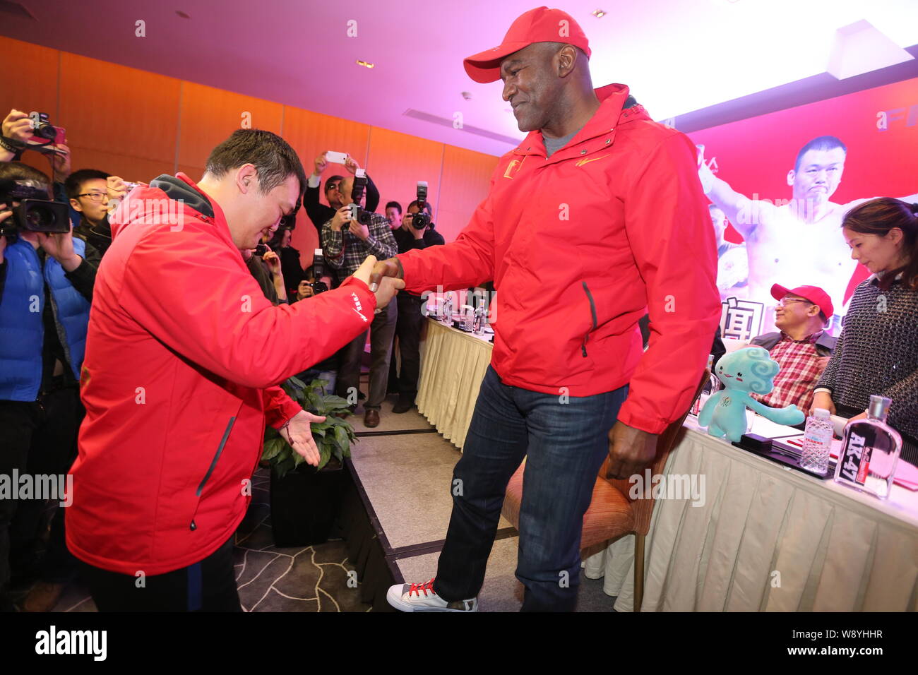 Chinese professional boxer Zhang Junlong, left, shakes hands with ...