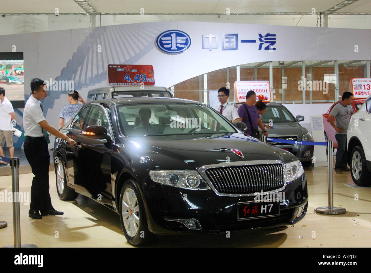 --FILE--Visitors look at or try out a Hongqi (Red Flag) H7 limousine ...