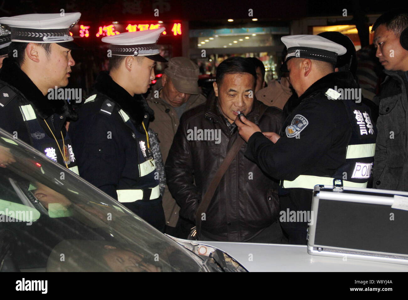 --FILE--Police officers detect the alcohol level in the blood of a ...