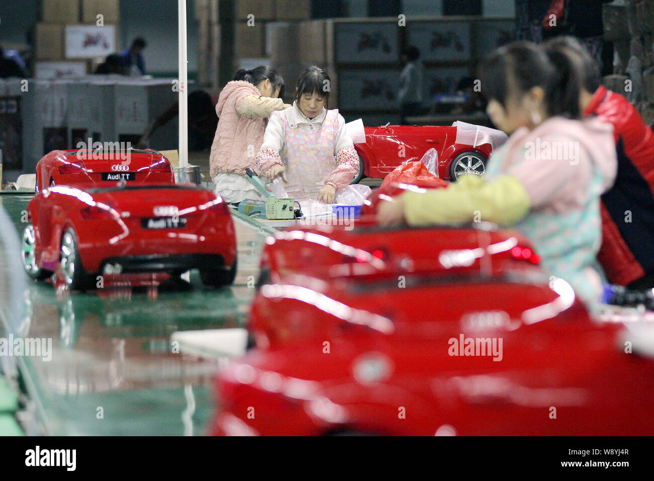 --FILE--Chinese workers assemble electric toy cars on the production ...