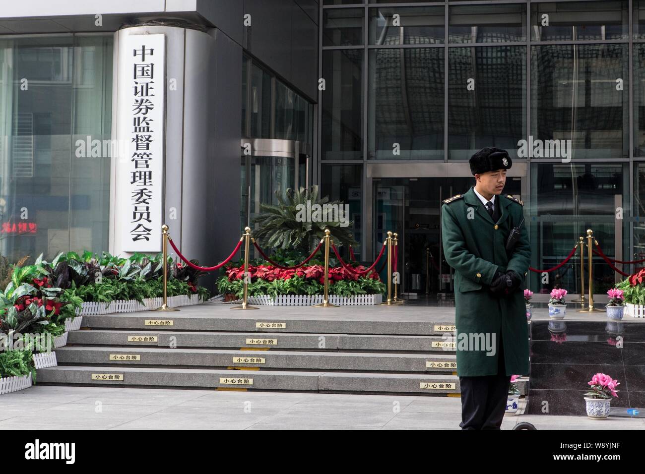 --FILE--A security guard stands in front of the headquarters of the ...