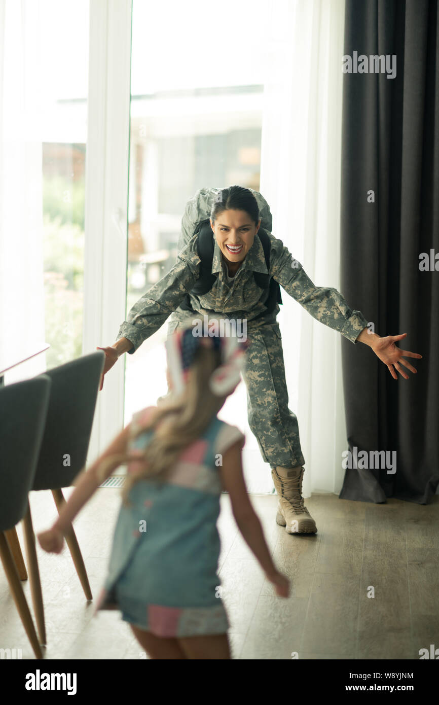 Emotional military woman crying while seeing her little daughter Stock ...