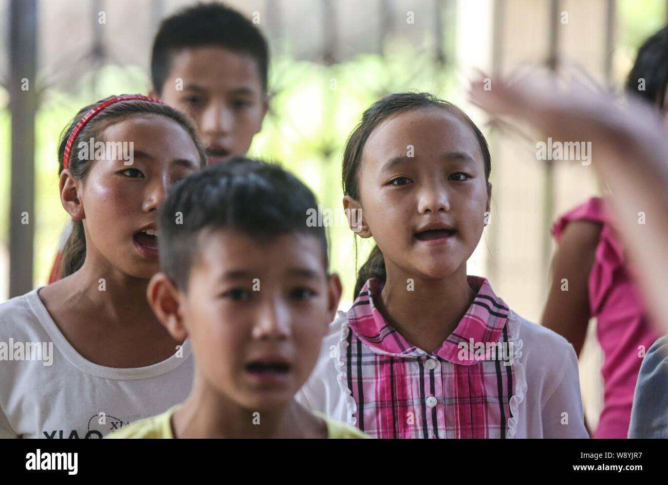64-year-old teacher Kang Li, unseen, directs young kids from Daliang ...