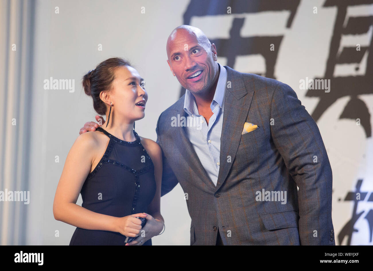 American actor Dwayne Johnson, right, listens to a female interpreter ...