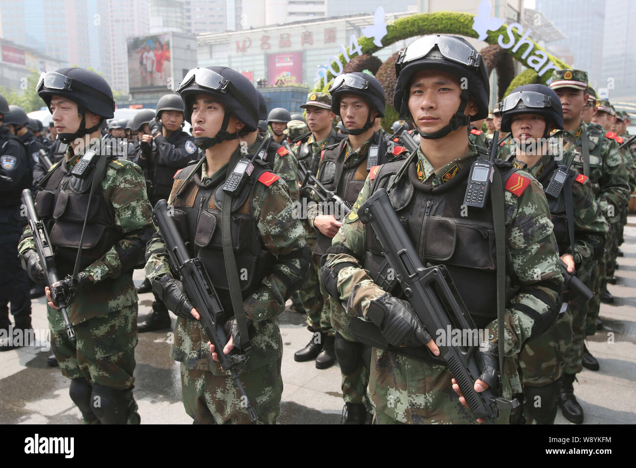 SWAT police officers armed with guns stand guard at the square of the ...
