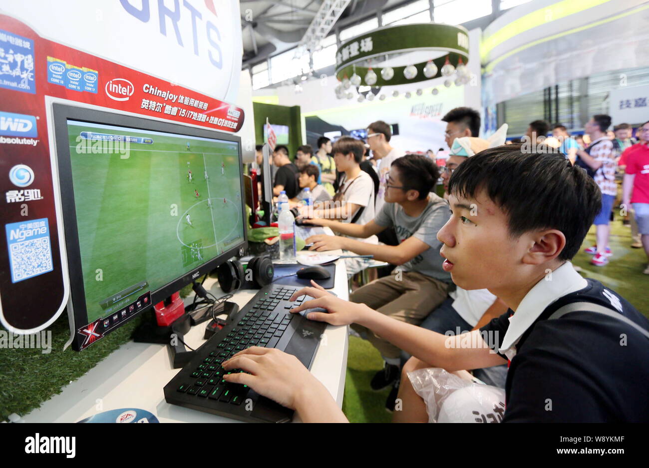 Visitors play electronic football games on desktop computers during the ...