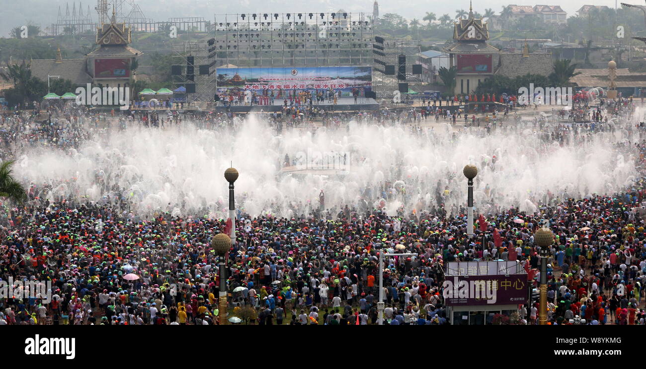 Crowds of local people splash water to celebrate the New Year of Dai ...
