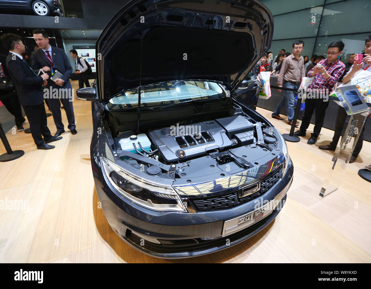--FILE--Visitors take photos of a Qoros 3 Sedan during the 15th ...