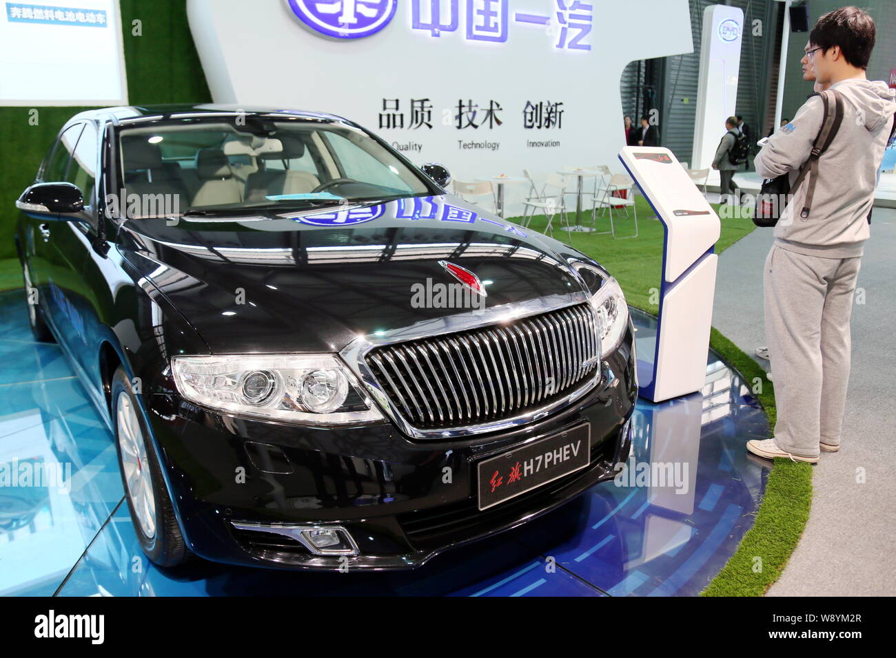 Visitors look at a Hongqi (Red Flag) H7PHEV of FAW on display at the ...