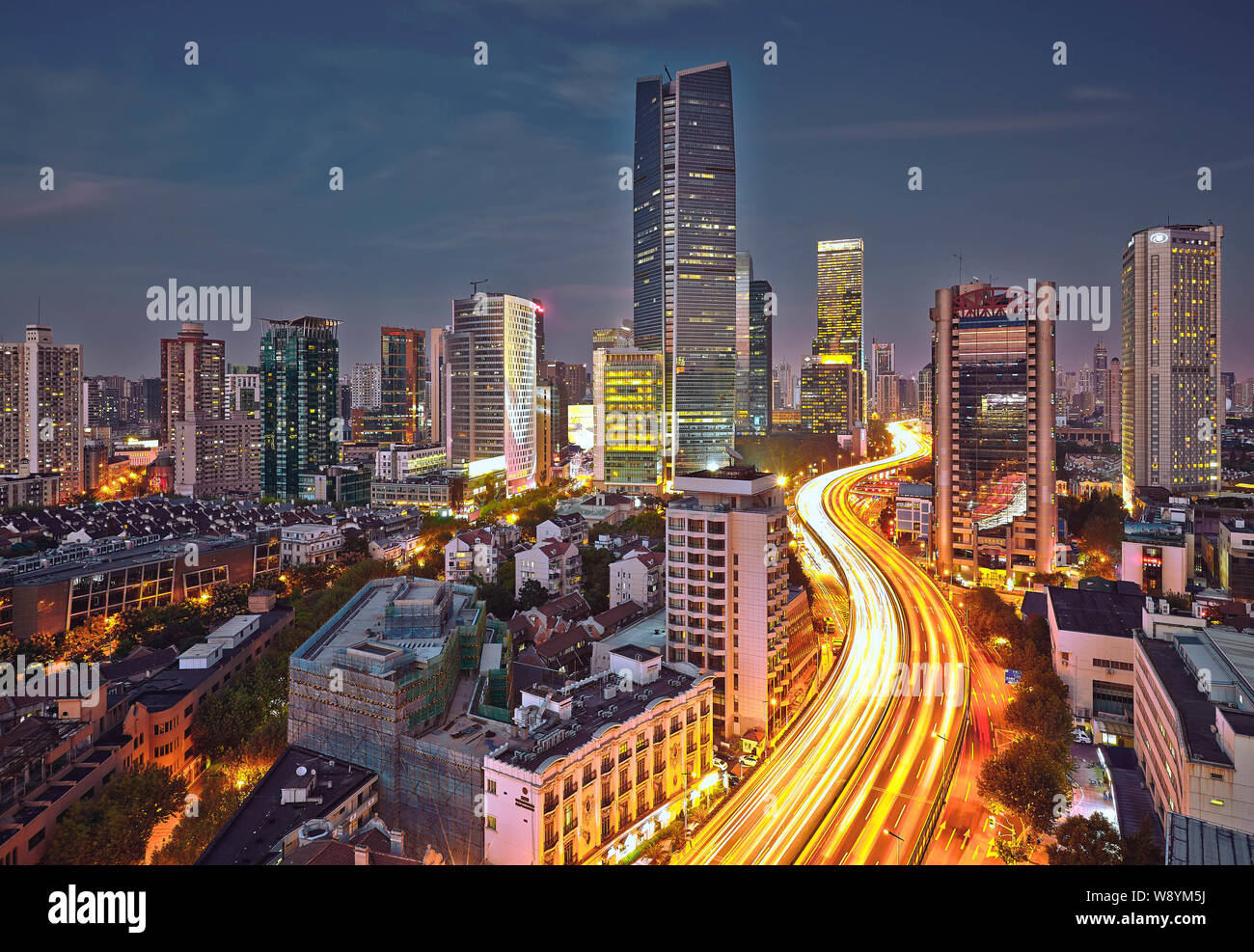 Night view of elevated highways next to high-rise buildings in downtown ...