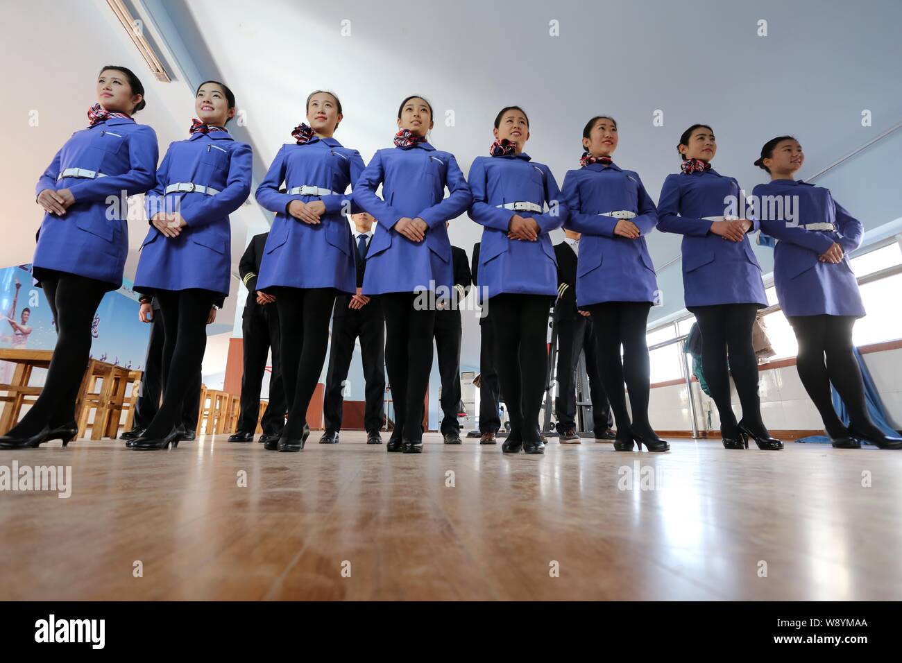 Young Chinese students pose during a flight attendant training session ...