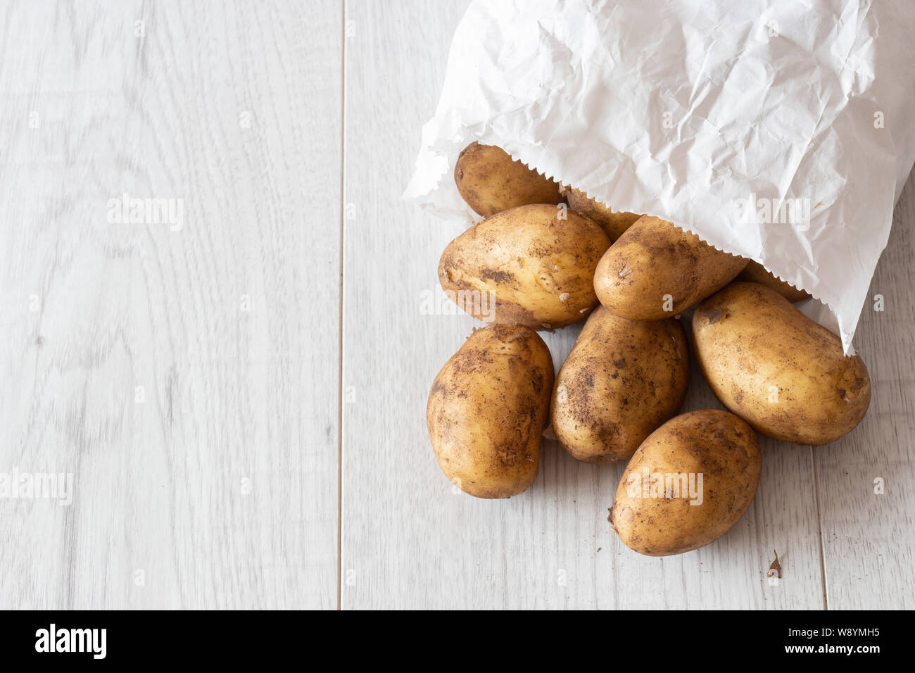 New potatoes in a white paper bag, environmentally friendly ...