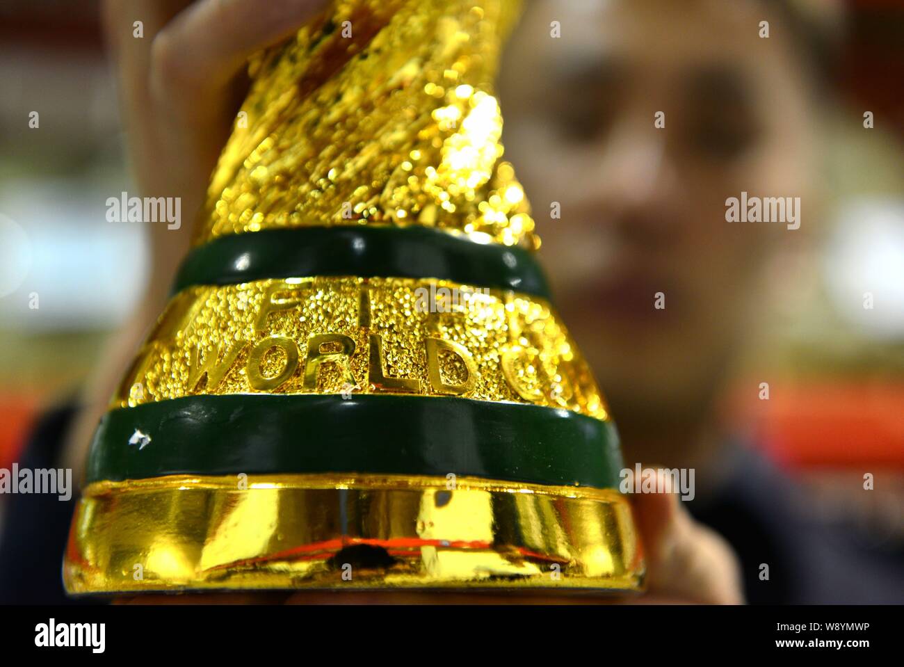A Chinese customs officer shows a seized fake World Cup trophy at a ...