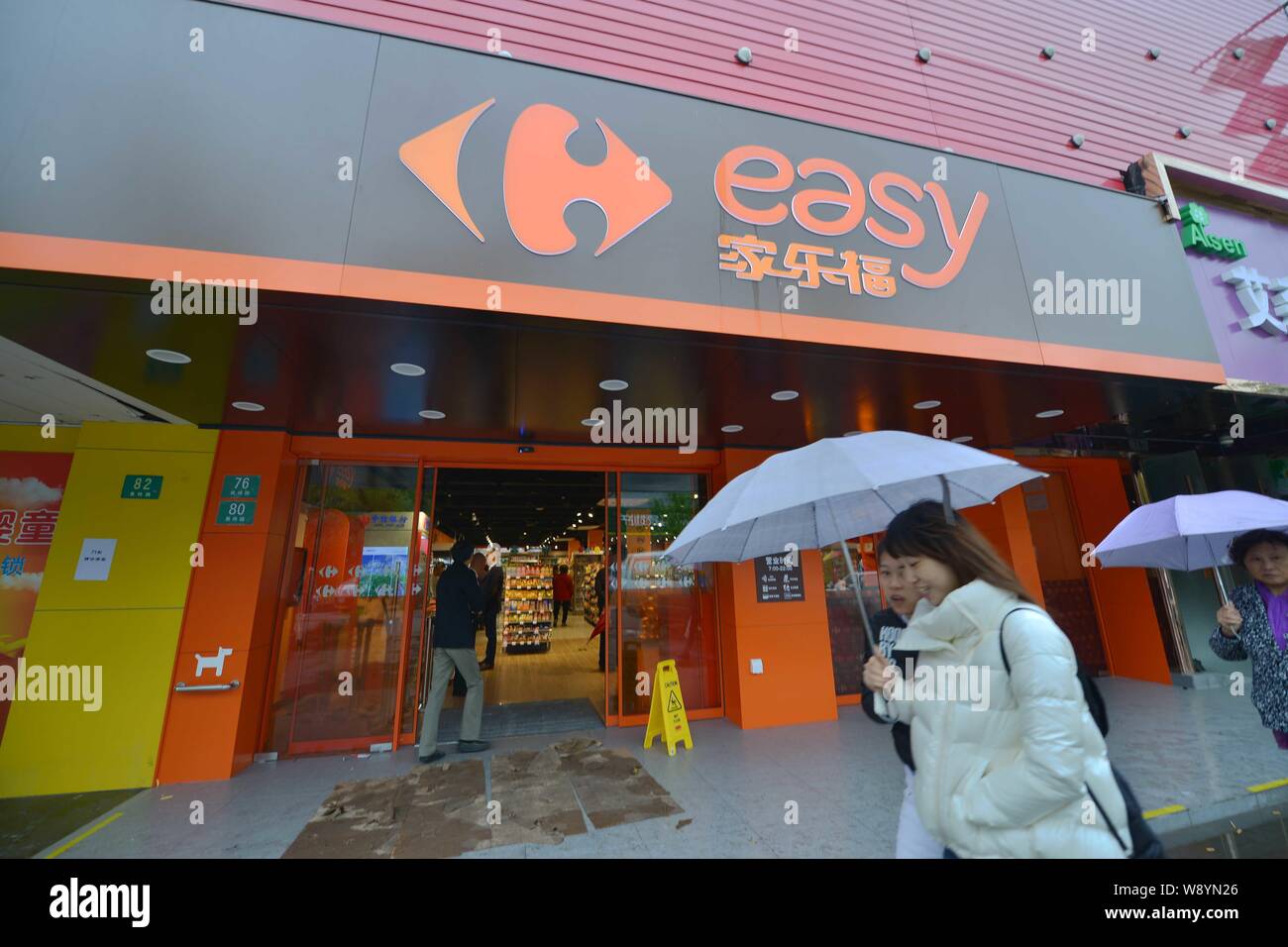 Pedestrians walk past an Easy Carrefour convenience chain store in ...