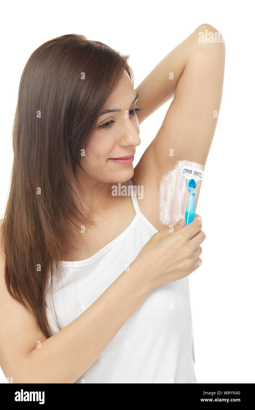 Young woman shaving her armpit Stock Photo - Alamy