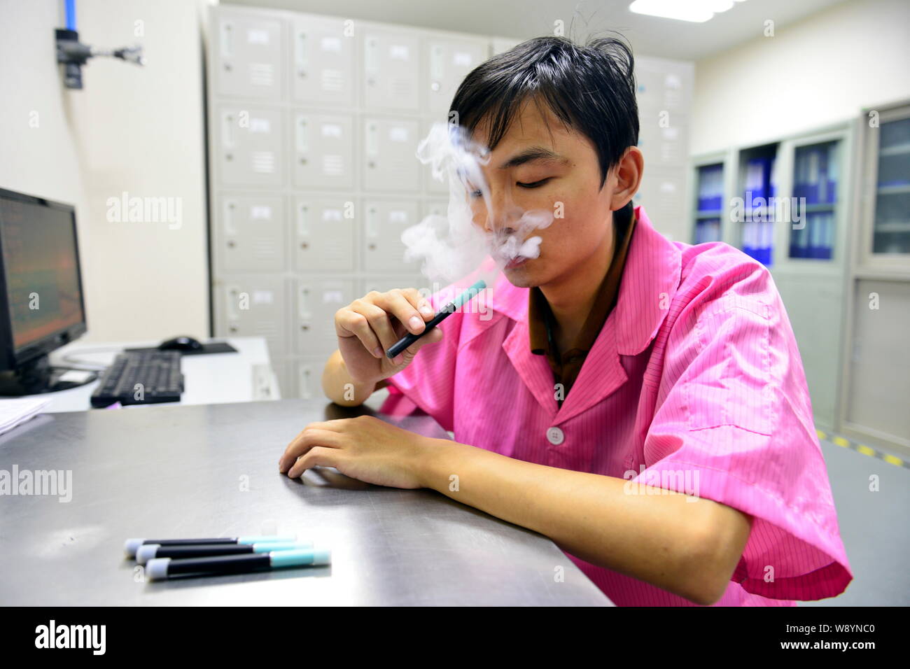 --FILE--A Chinese employee tests electronic cigarettes in a lab at the ...