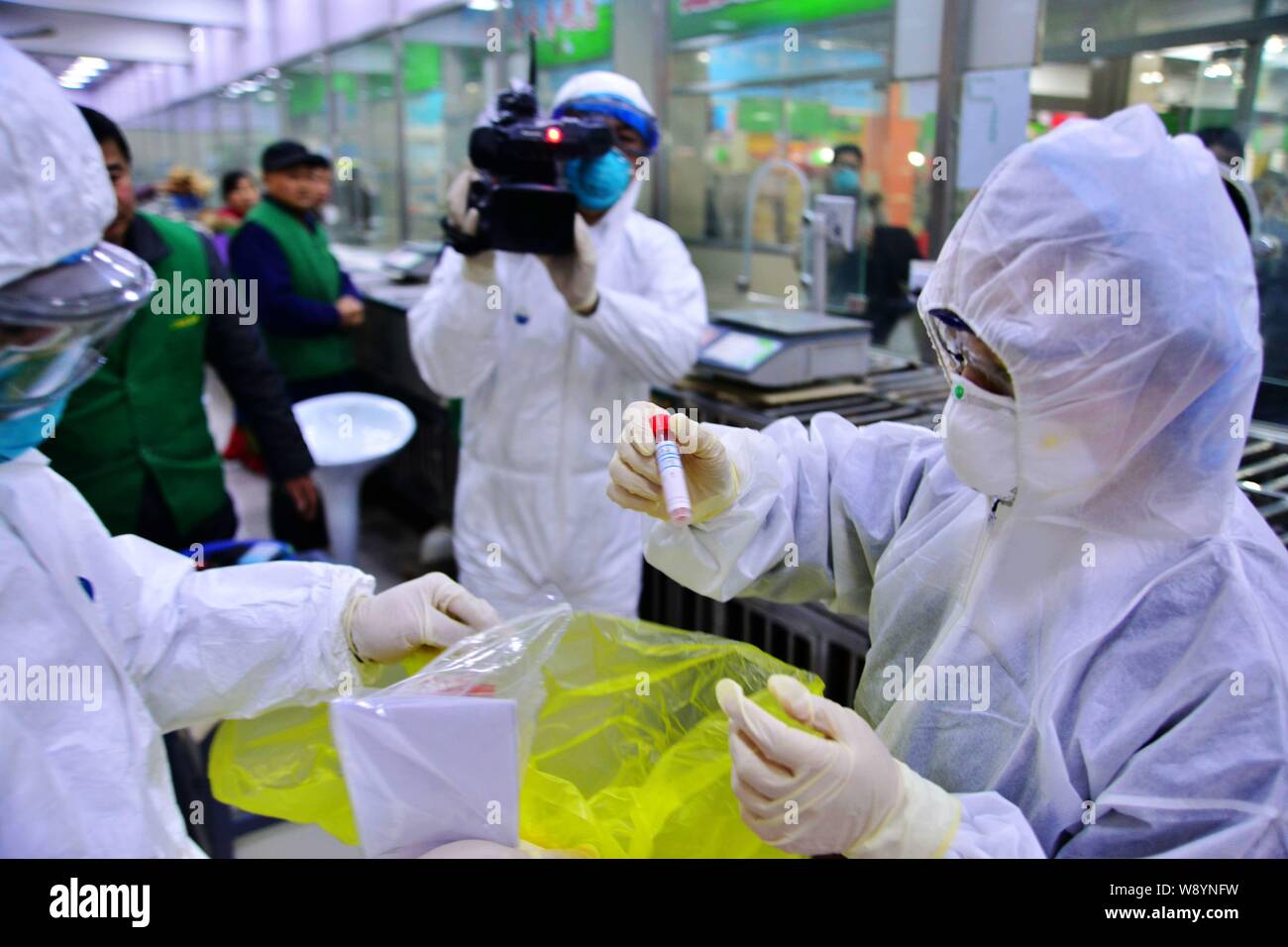 Staff member, front two, from the Hongkou District Center for Disease ...