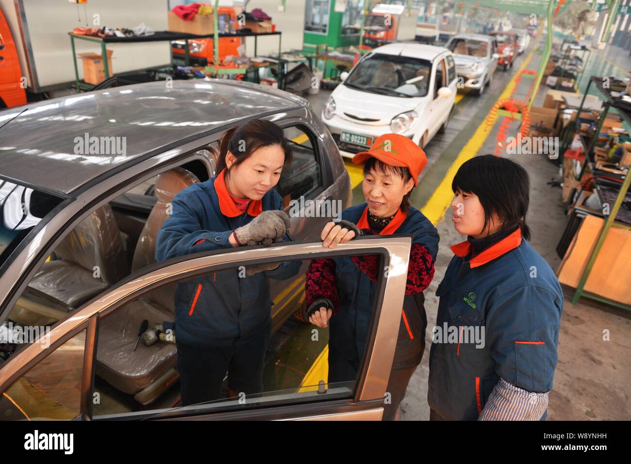 --FILE--Female Chinese workers assemble a car on the assembly line at ...