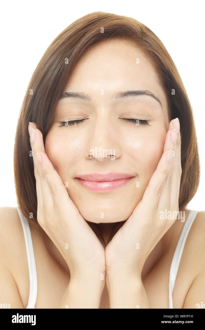 Close up of a woman touching her cheeks Stock Photo - Alamy