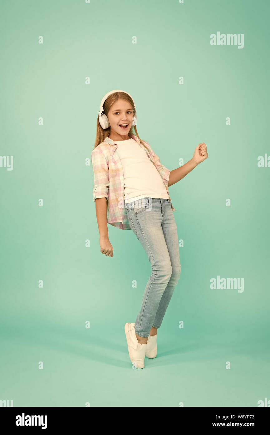 Following driving dance tracks. Cute child enjoying happy dance music ...