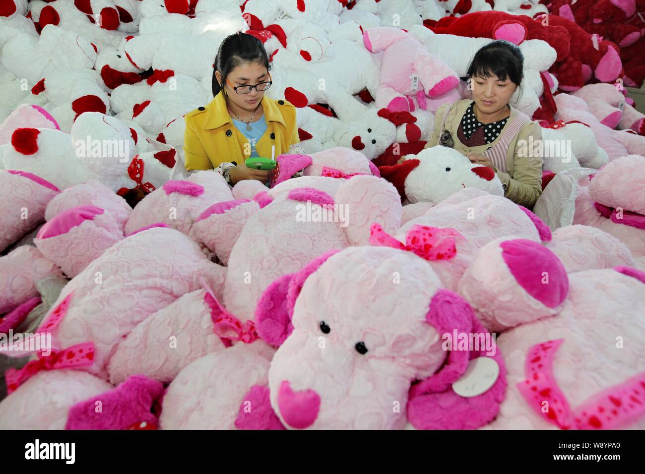 Female Chinese workers sew stuffed toys to be exported to Europe and ...
