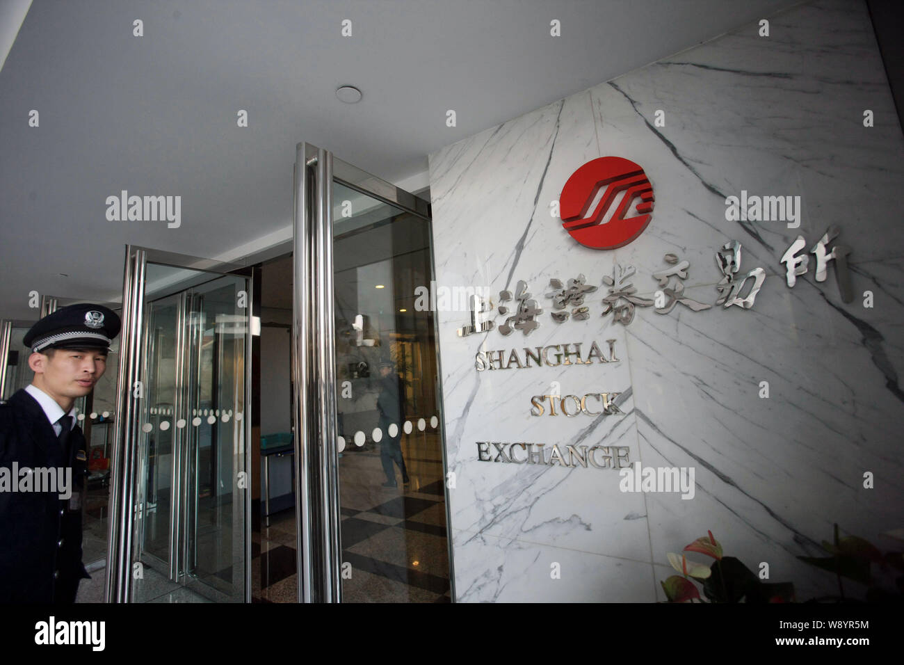 --FILE--A security guard stands in front of the Shanghai Stock Exchange ...