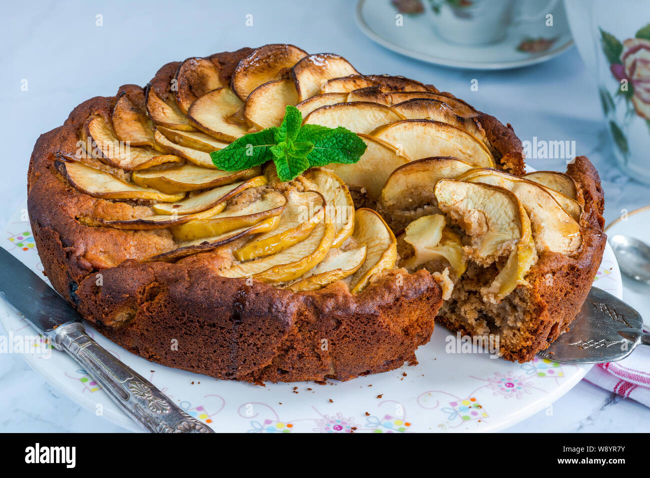 Apple, ginger and honey cake garnished with fresh mint Stock Photo - Alamy