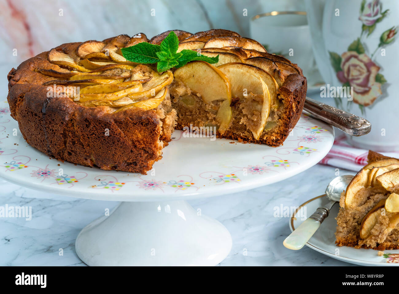 Apple, ginger and honey cake garnished with fresh mint Stock Photo - Alamy