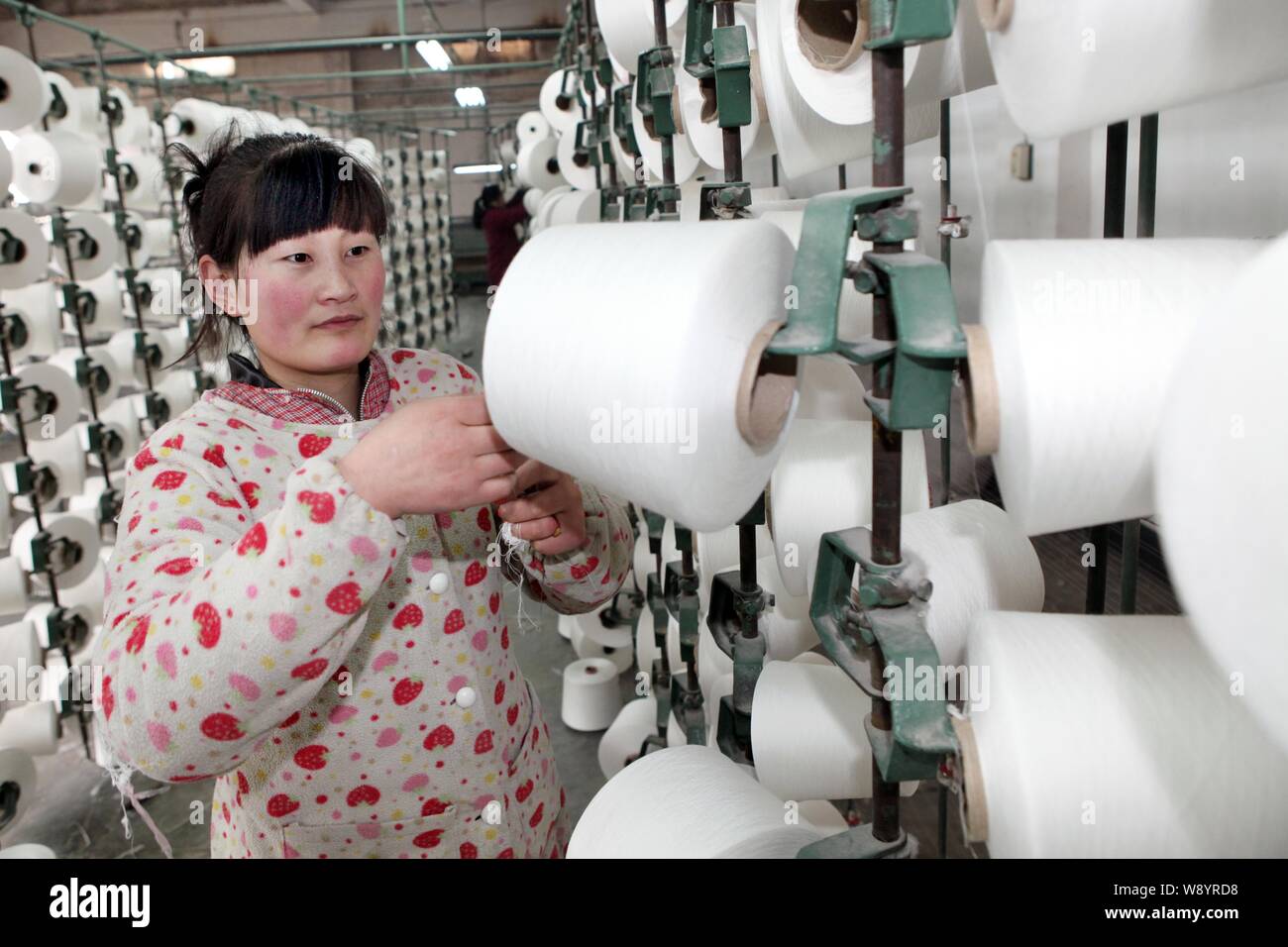 --FILE--Female Chinese workers handle production of yarn at a textile factory in Ganyu county ...
