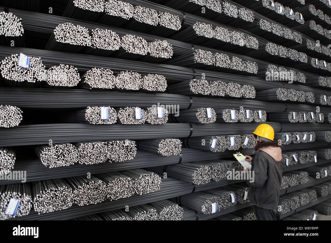 --FILE--A Chinese worker examines reinforcing steel rods at a plant in ...
