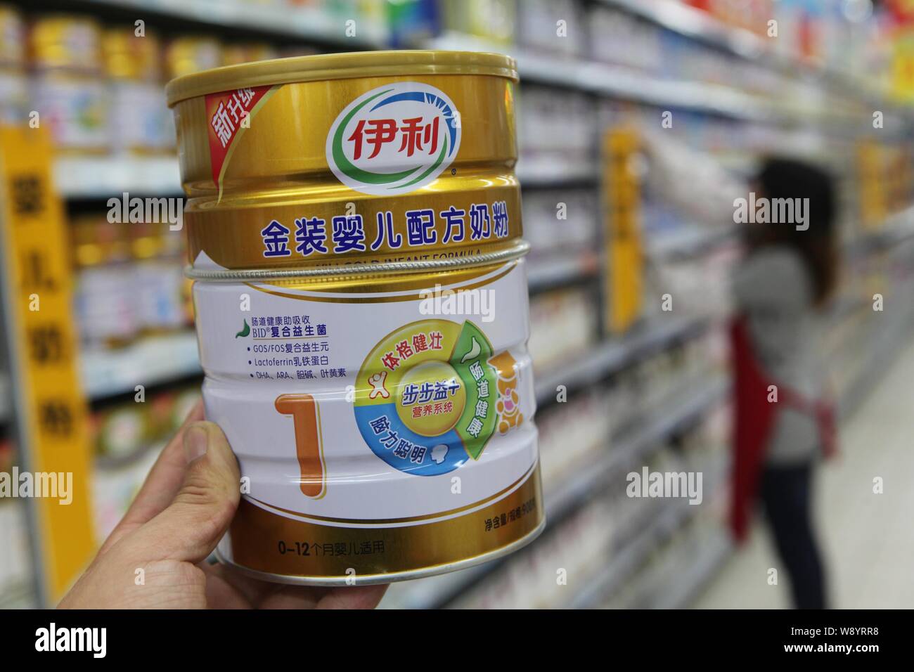 --FILE--A customer buys a tin of Yili baby formula at a supermarket in ...