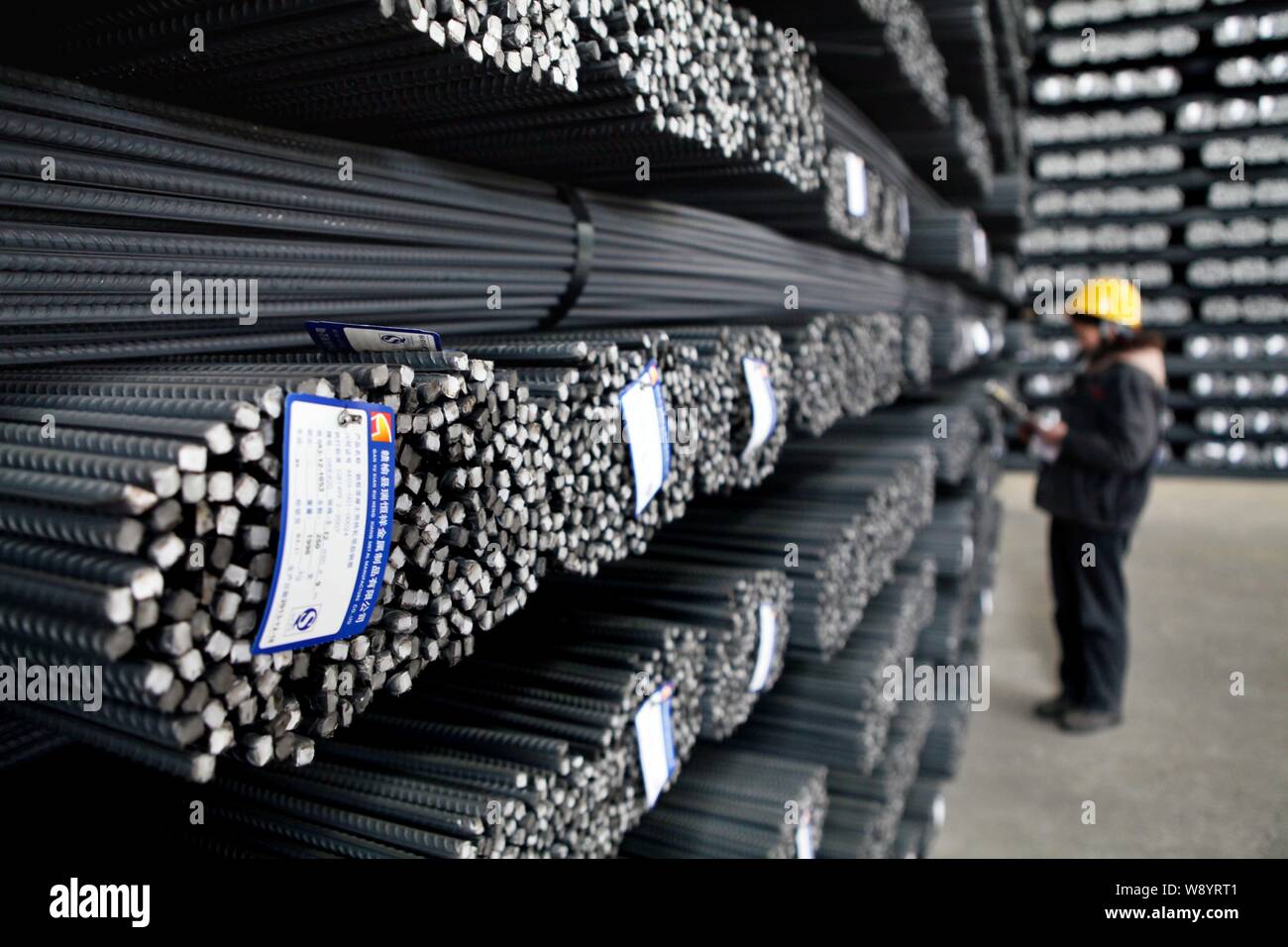--FILE--A Chinese worker examines reinforcing steel rods at a plant in ...
