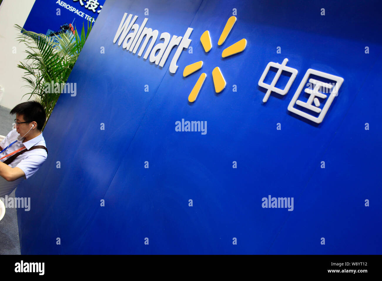 --FILE--A visitor sits at the stand of Walmart during an exhibition in ...