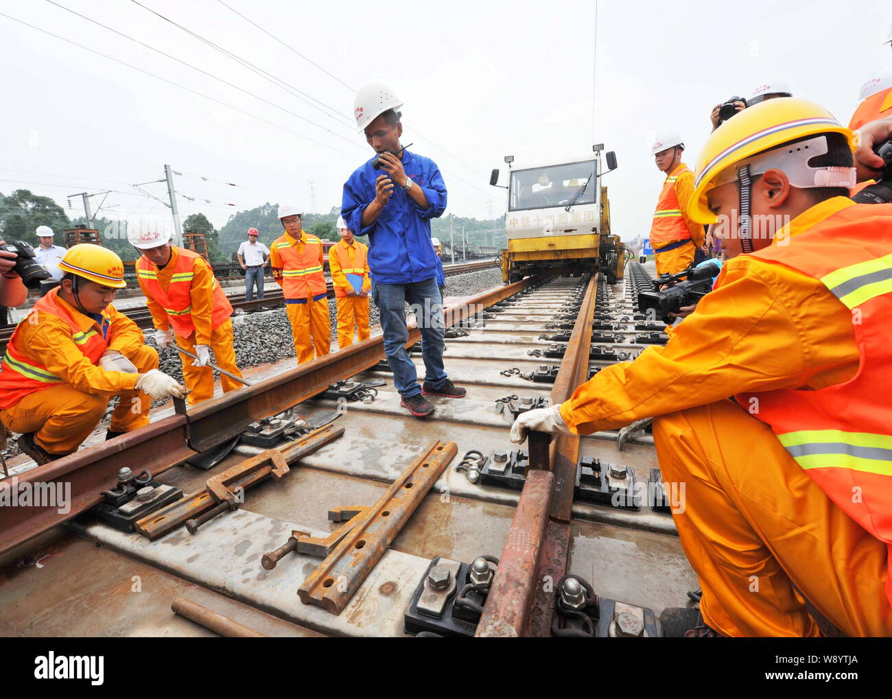 --FILE--Chinese workers pave rails at a construction site of ...
