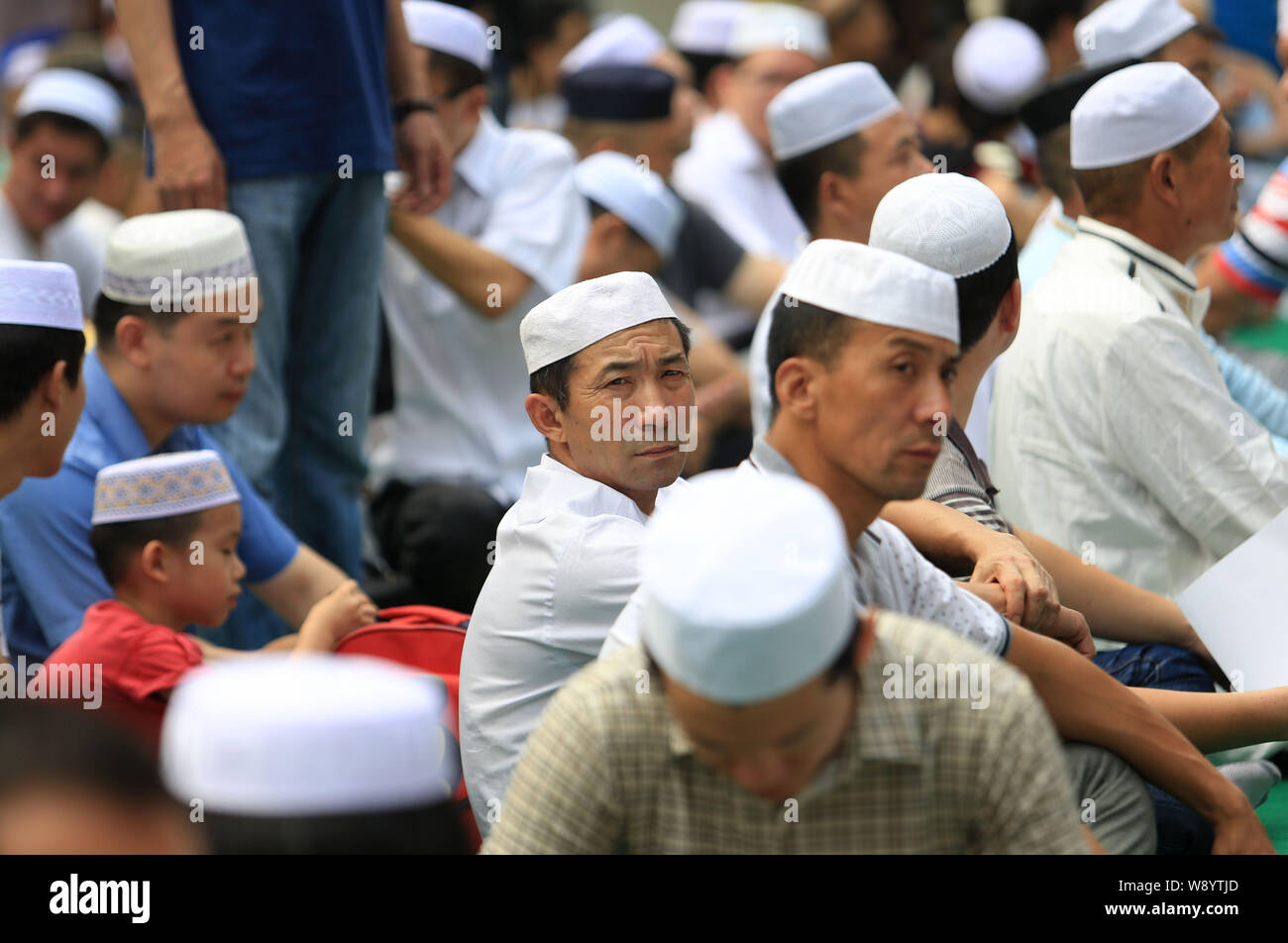 Chinese Muslims attend an Eid al-Fitr morning prayer session at a ...