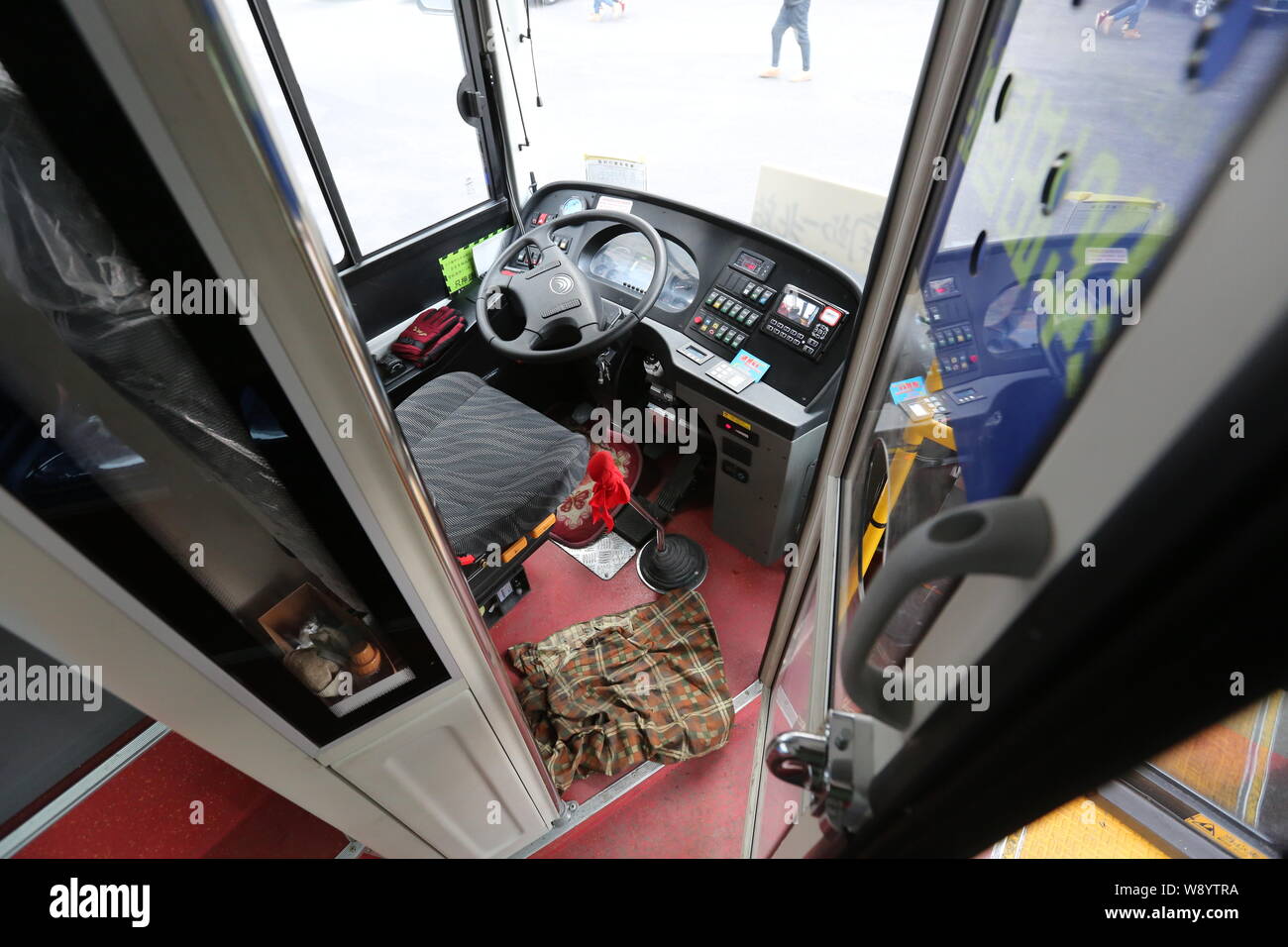 A shield door is equipped on a bus to protect bus drivers after a ...