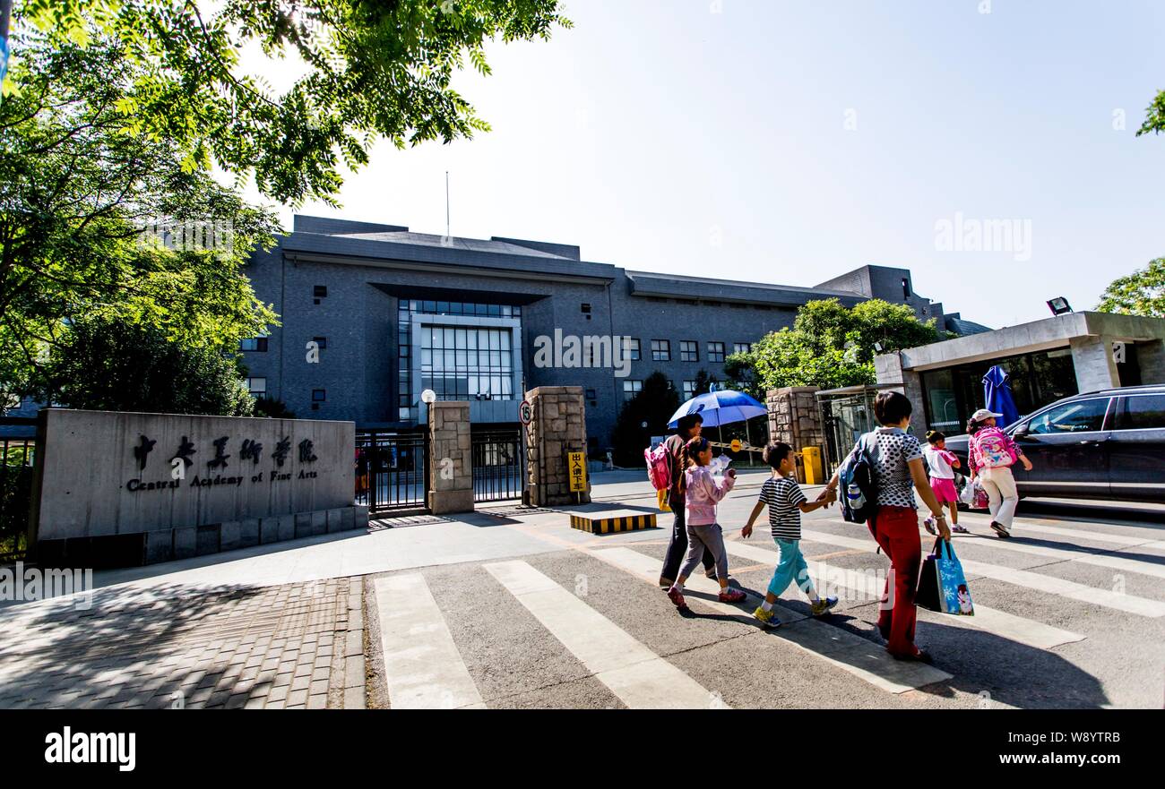 Pedestrians walk past the gate of Central Academy of Fine Arts (CAFA ...