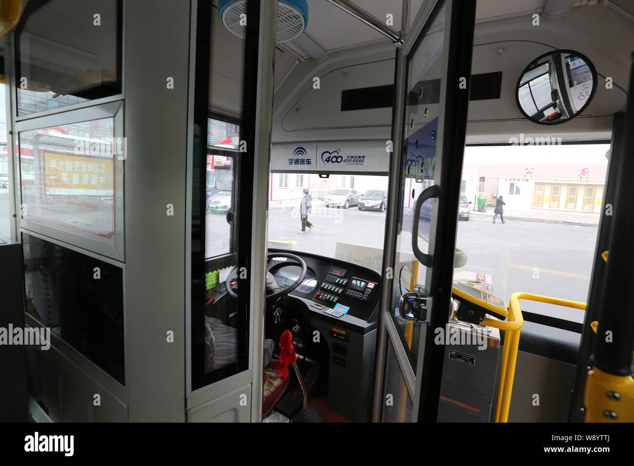 A shield door is equipped on a bus to protect bus drivers after a ...