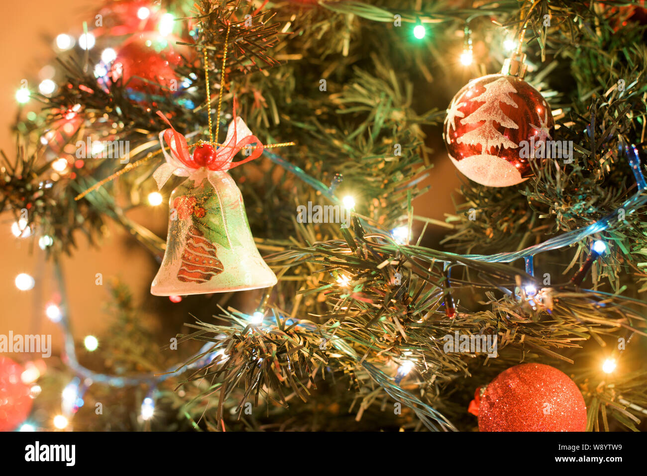 Beautiful decorated christmas tree with balls and bells. Holiday ...