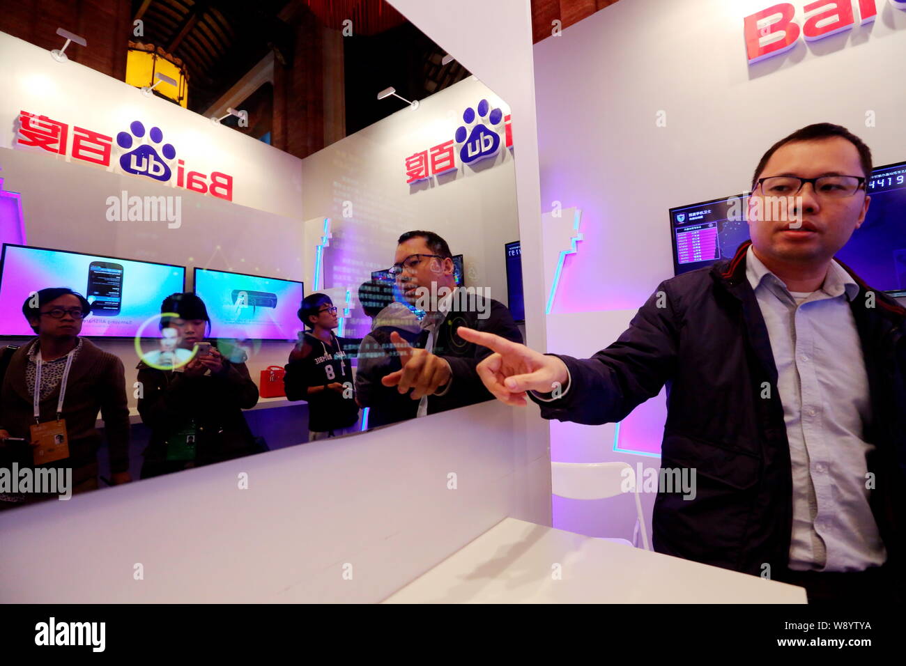 --FILE--A Chinese employee points to a screen at the stand of Baidu ...