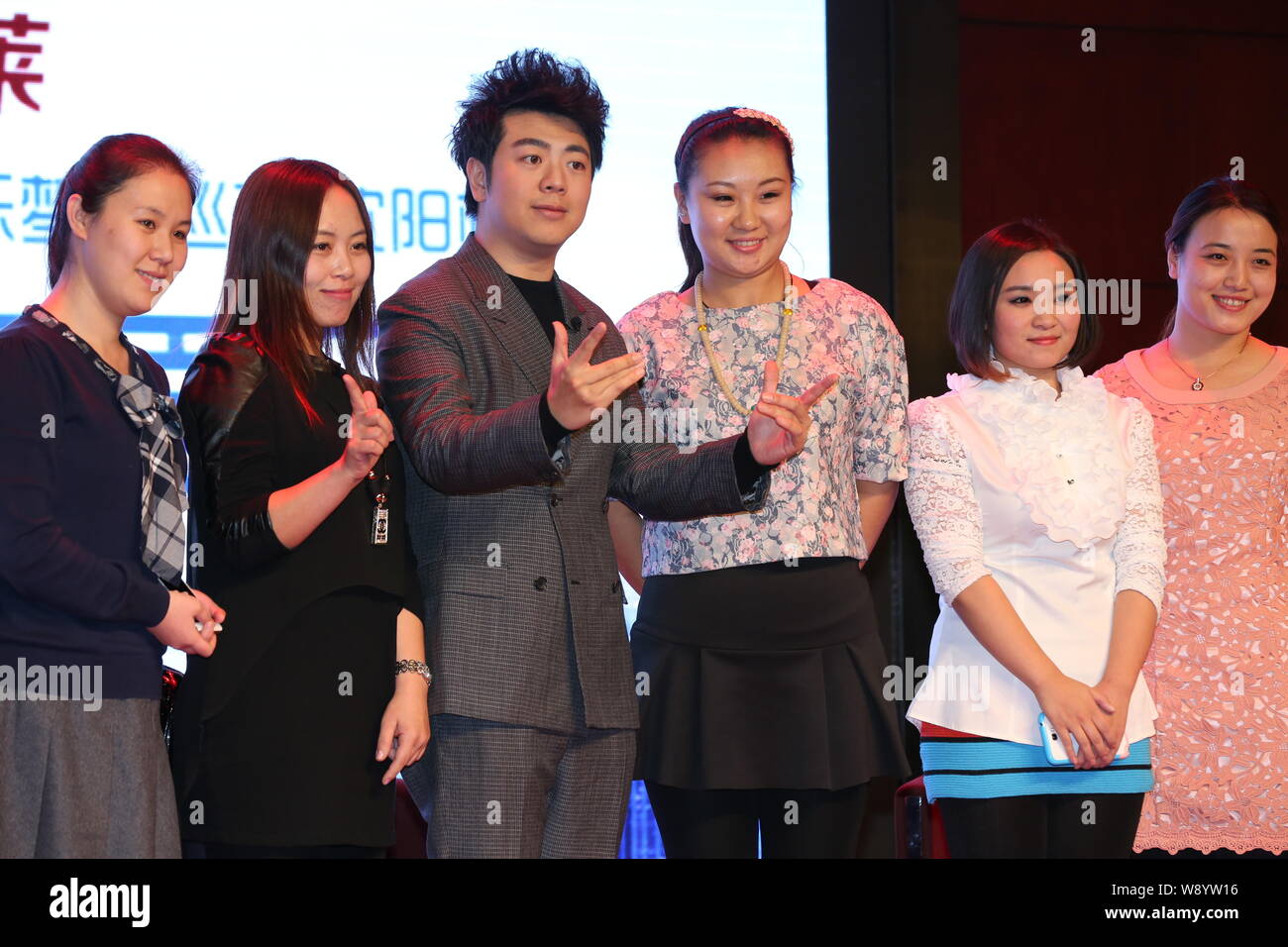 Chinese pianist Lang Lang, third left, poses with fans during a press ...