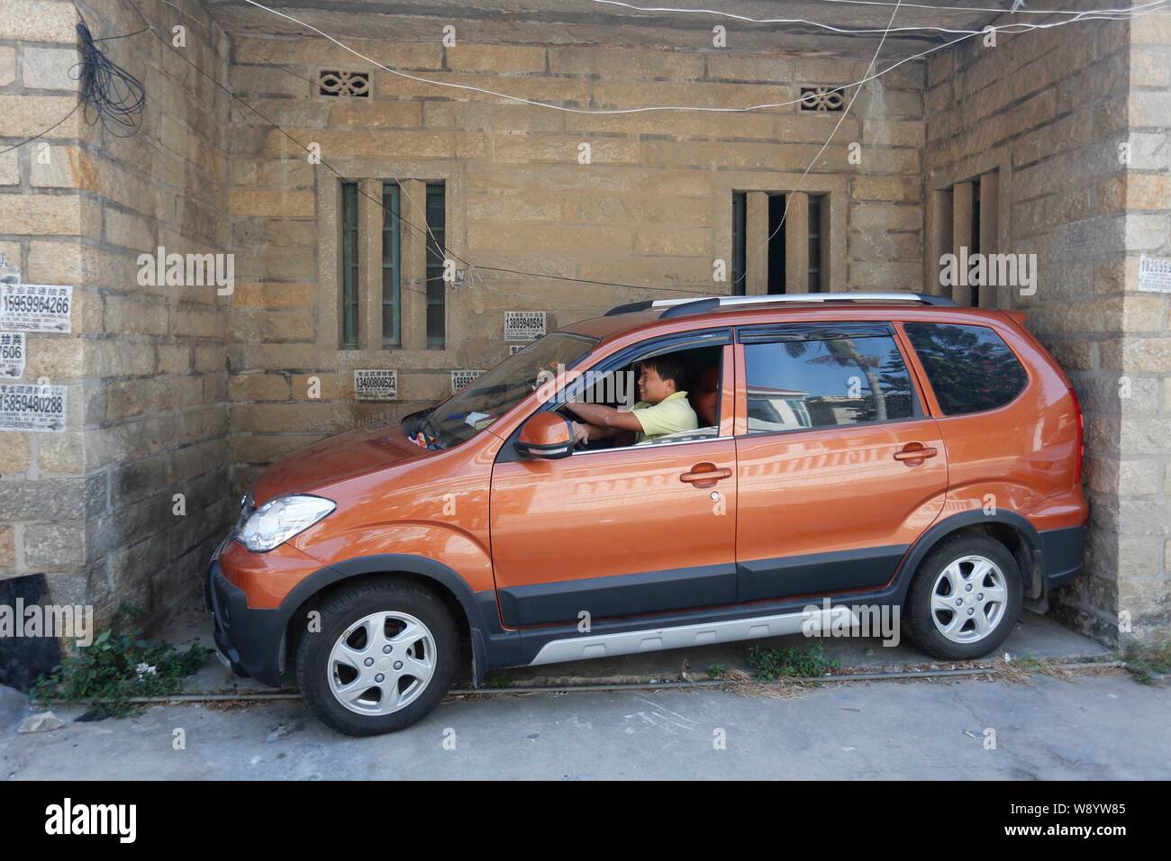 Chinese driver Chen Zhongliang demonstrates pulling his car out of a ...