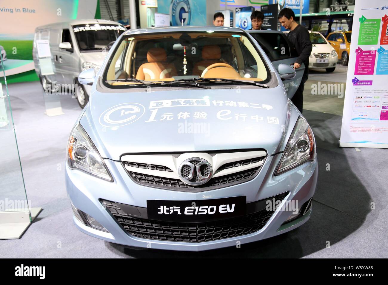 --FILE--Visitors look at an E150 EV of BAIC Motor on display at the 16th China International ...